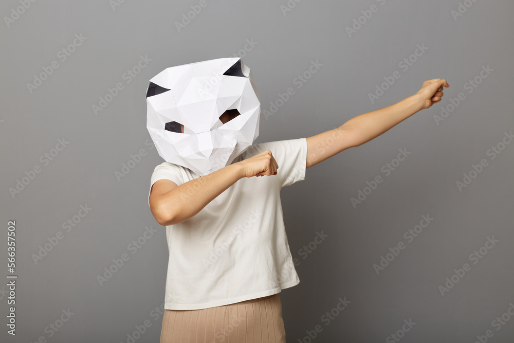 Indoor shot of woman wearing cat paper mask and white T-shirt posing ...
