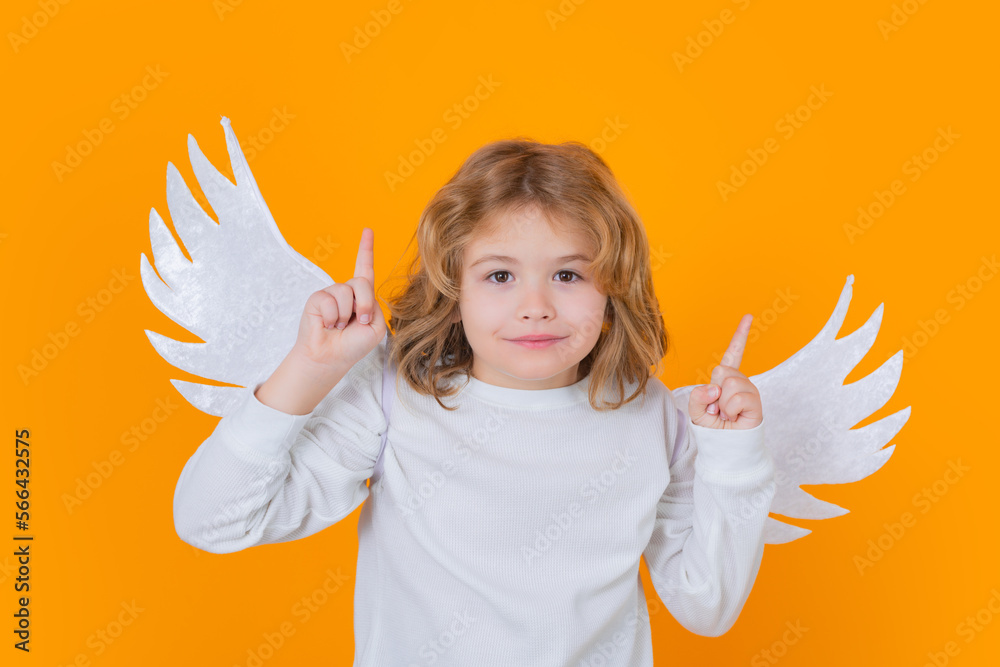 Child angel pointing up, point gesture, idea. Cute angel child, studio ...