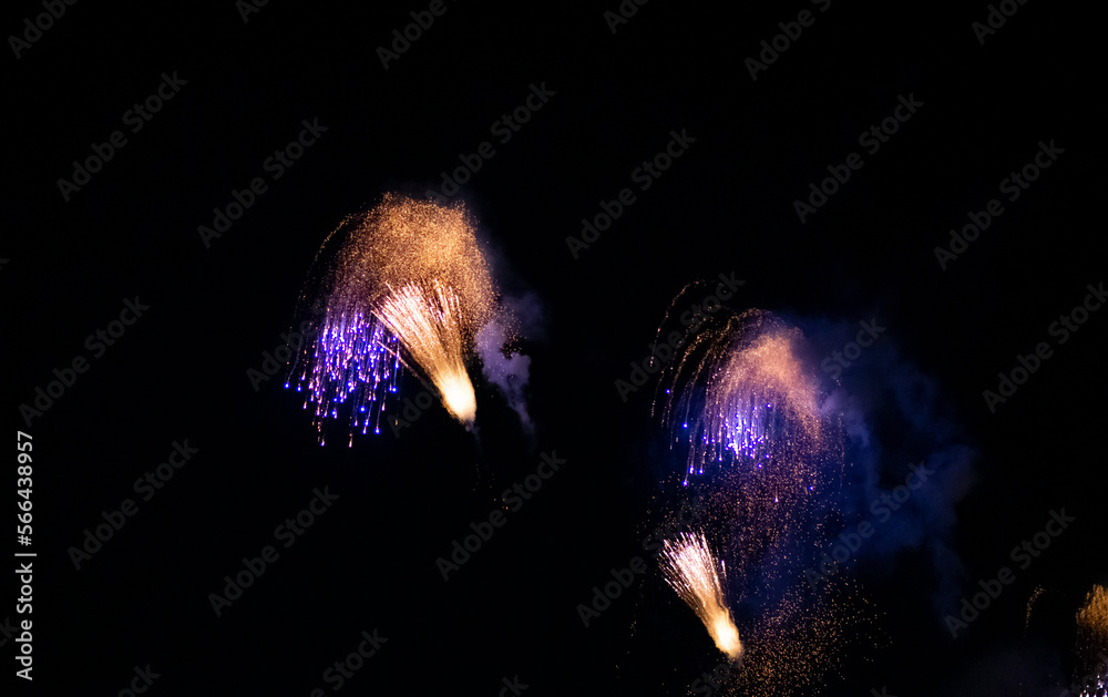 Huge fireworks explosions with Violet and golden colors over a party in ...