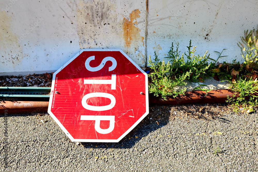 Stop Sign Laying on the Street Next to Barrier, Center of Frame Stock ...