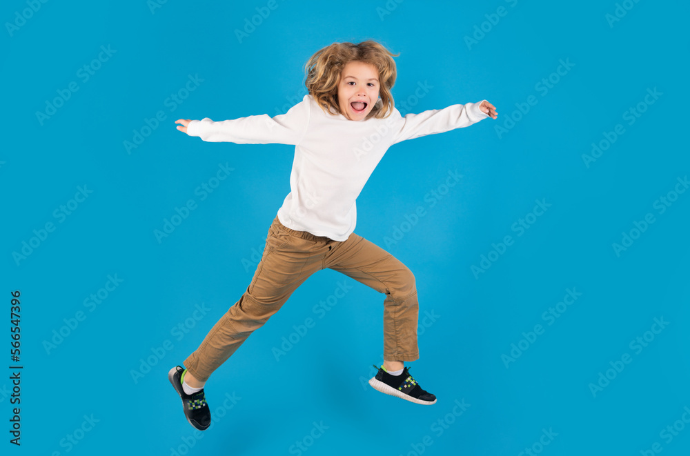 Full length body size of carefree child jump isolated over blue ...