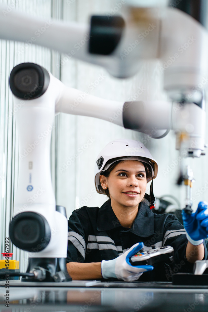 Computer science development engineer working on robotic arm connection ...