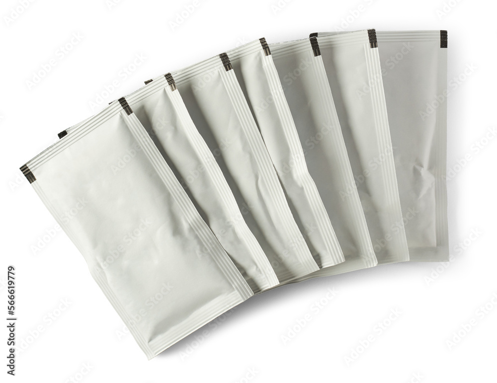 stack of blank white sachet packets isolated, close-up of food or ...