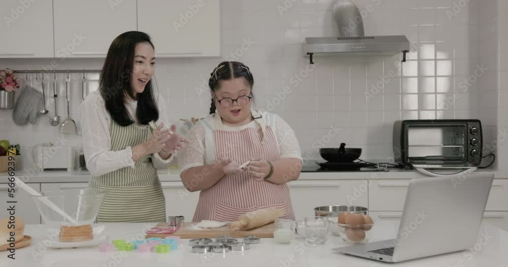 Autistic child practicing cake baking with mother in the kitchen at ...