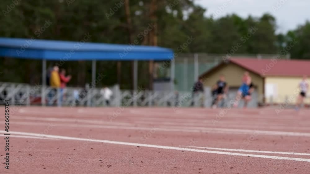male athletes run sprint race at stadium. slow motion, focus in ...