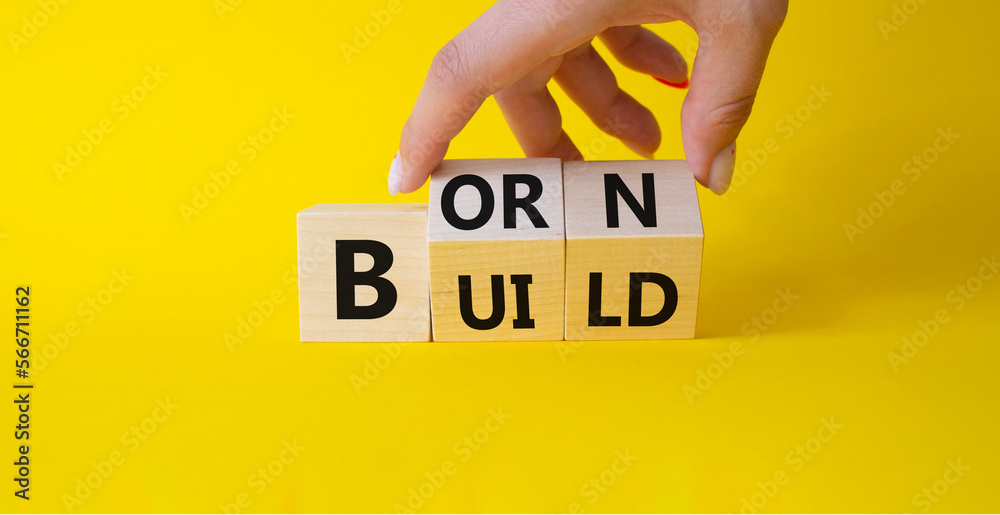 Born and Build symbol. Businessman hand turns wooden cubes and changes ...