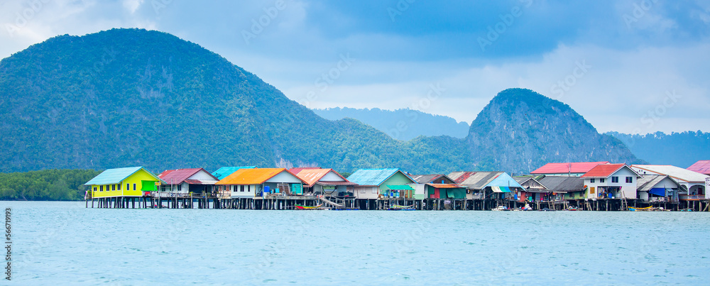 View of a fishing village in Thailand. Village on the water, cottages ...