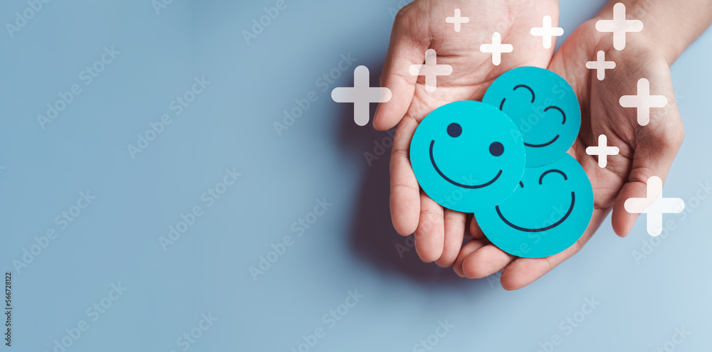 Hands holding blue happy smile face, good feedback rating, positive ...