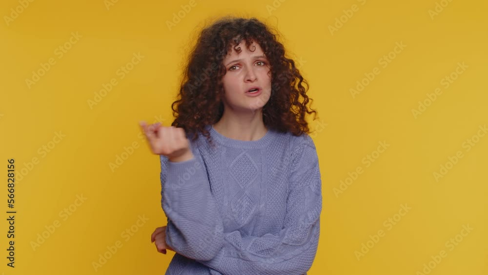 Quarrel. Displeased curly haired woman gesturing hands with irritation ...