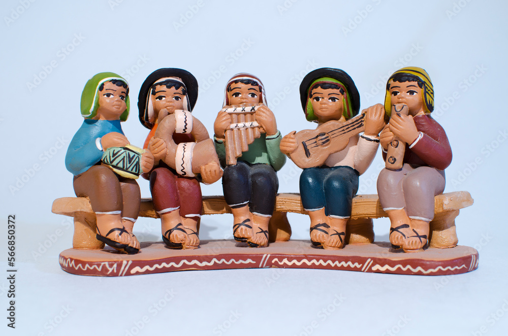 Peruvian handicraft in white background. Five musicians playing typical ...