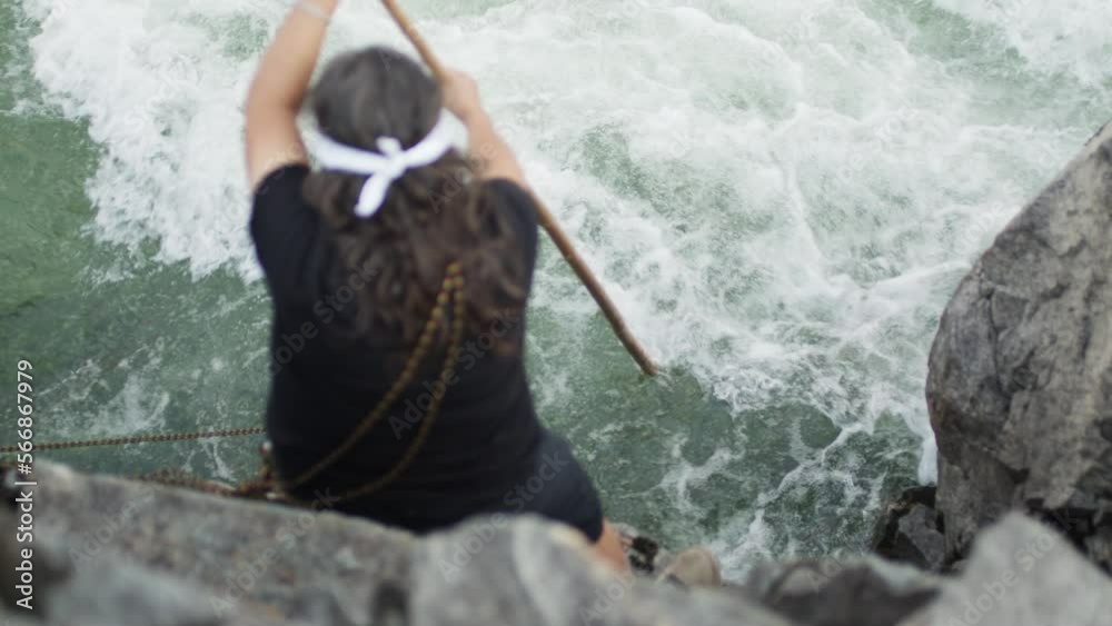 Traditional indigenous salmon fishing using dip nets on a river. First ...