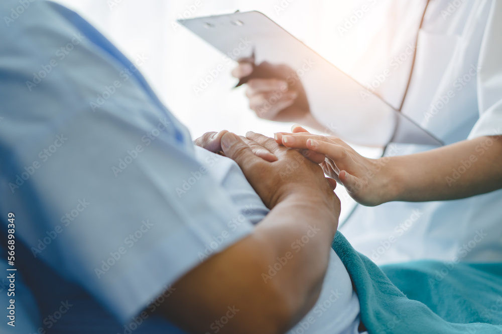 Doctor touching hands to encouragement mental of elderly patient after ...