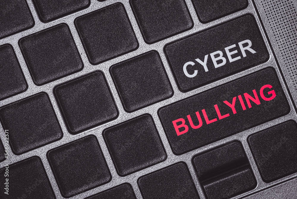 Cyber bullying word on button of laptop. Slander on social media. Bias ...