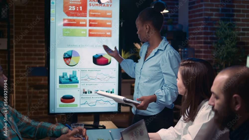 Employee speaking in business meeting presentation, holding report ...