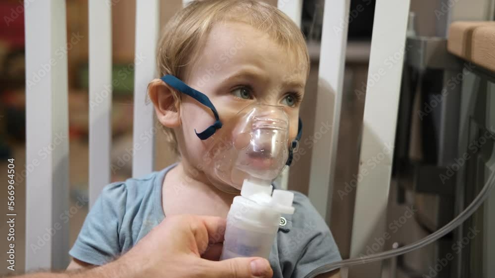 Sick Baby Girl with making Inhalation with a Mask on his Face sitting ...