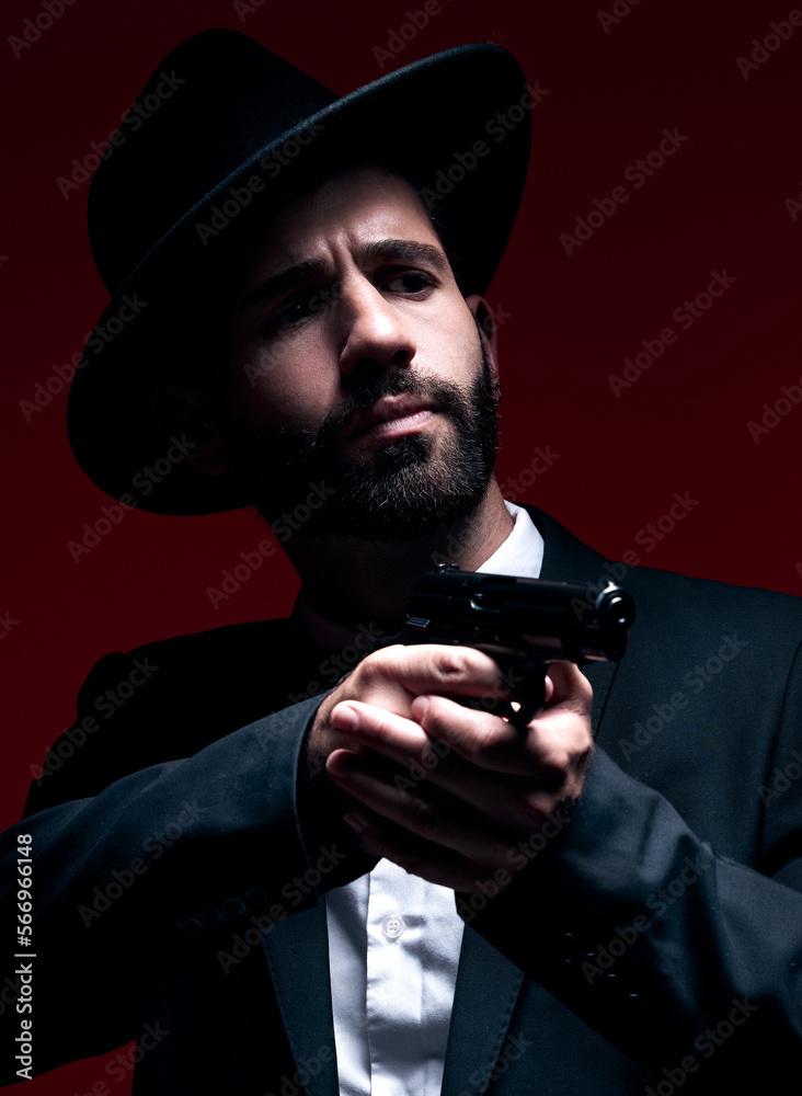 Assassin, suit or shooting weapon on studio background in dark secret ...