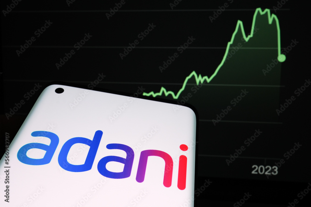 Adani Group logo seen on the smartphone screen and company stock price ...