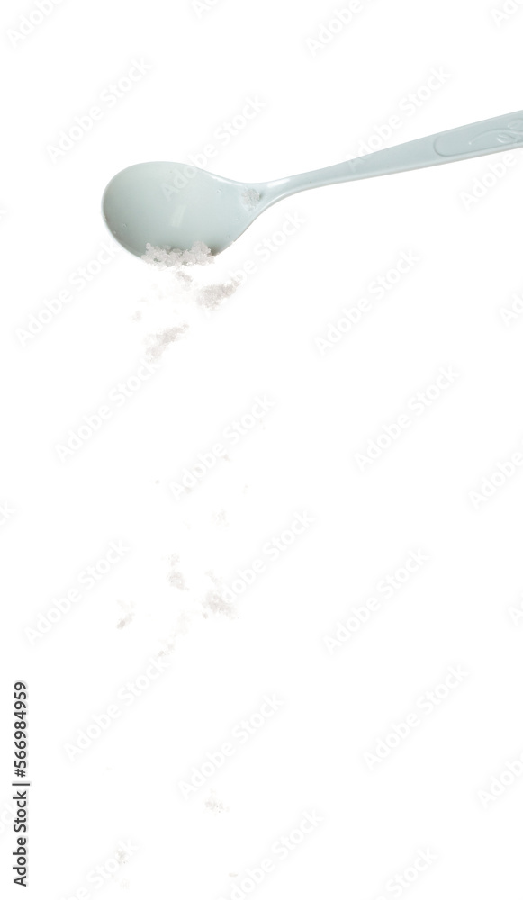 Crystal Salt fall down pouring in plastic spoon, flake white grain ...