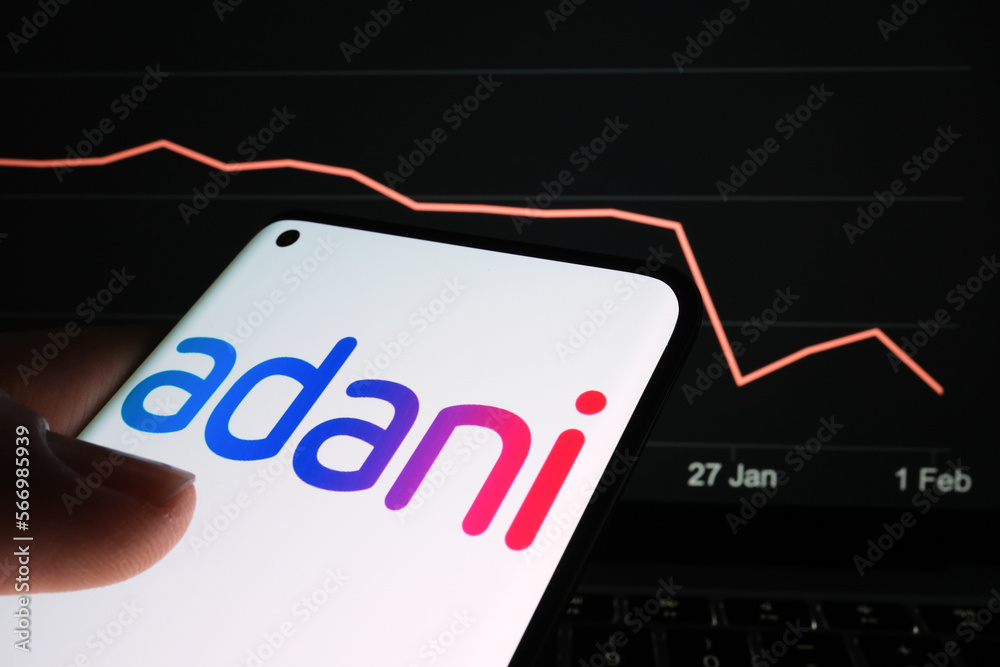 Adani Group logo seen on the smartphone screen and company stock price ...