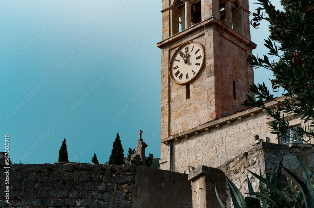 clocktower or belltower of old stone church building, typical clock ...