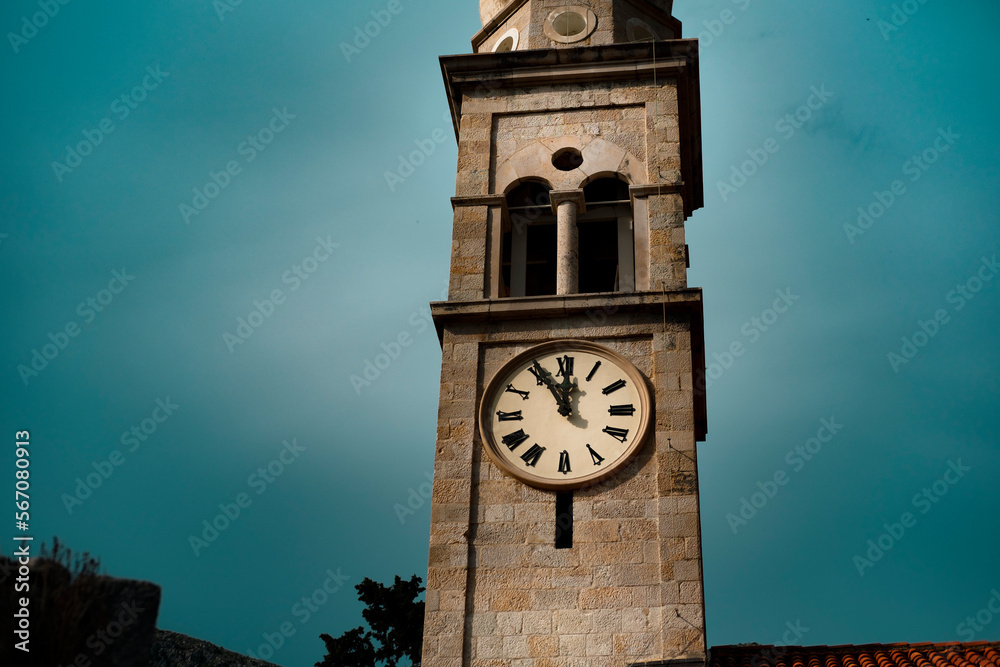 clocktower or belltower of old stone church building, typical clock ...