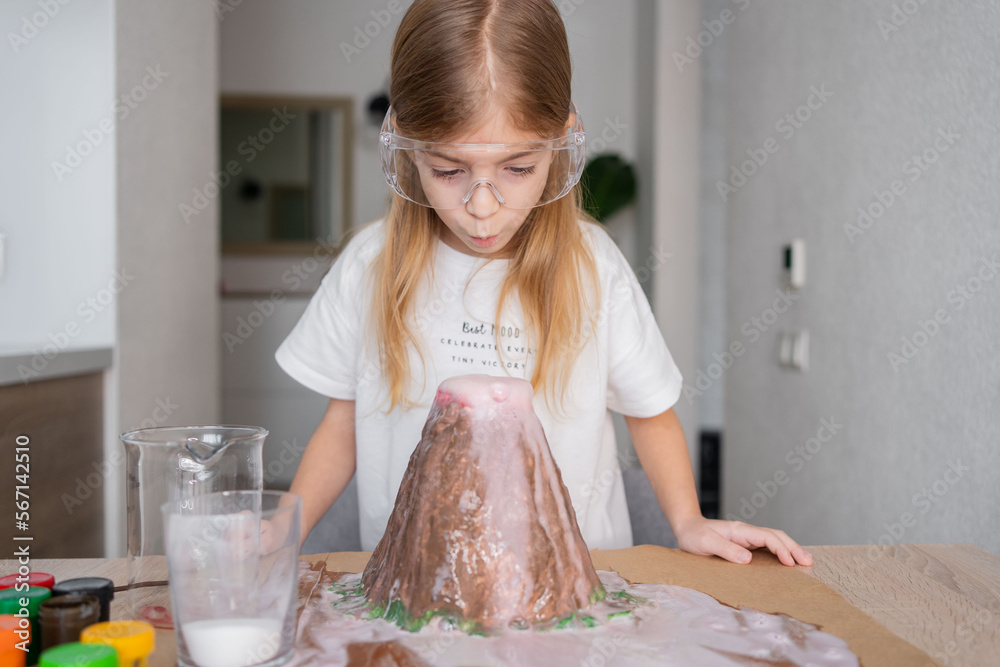 volcanic eruption. school science project. Kid girl watching a ...