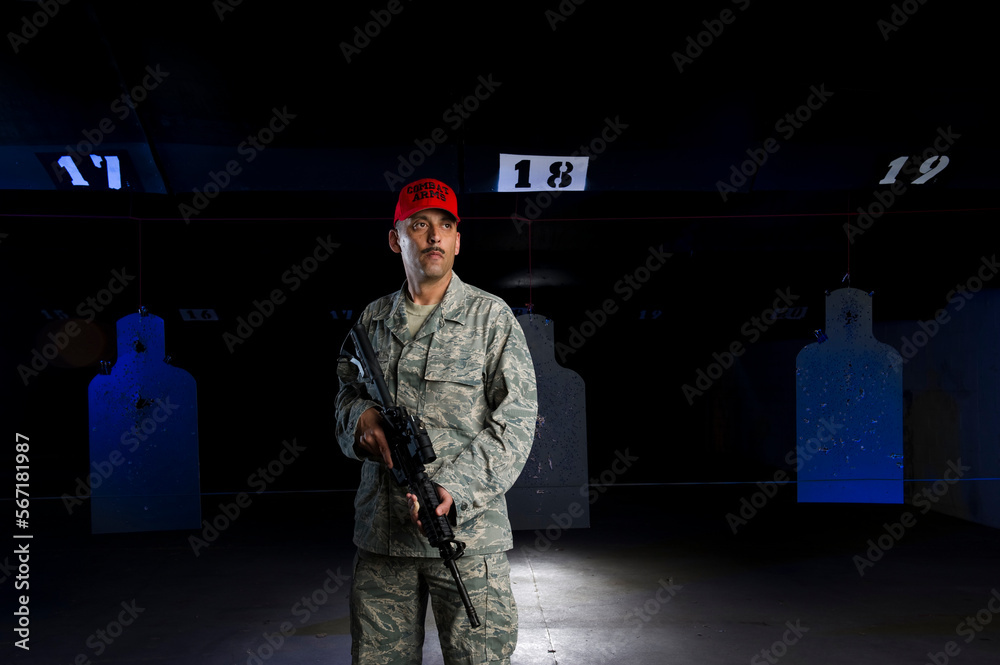A military police officer stands at the shooting range with his rifle ...