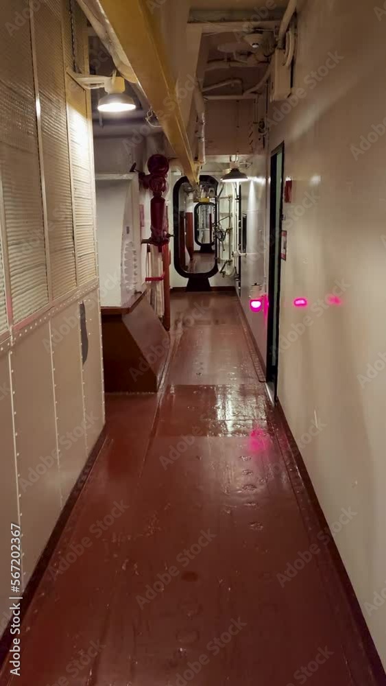 footage of inside the lower decks of the USS Alabama along the walkways ...
