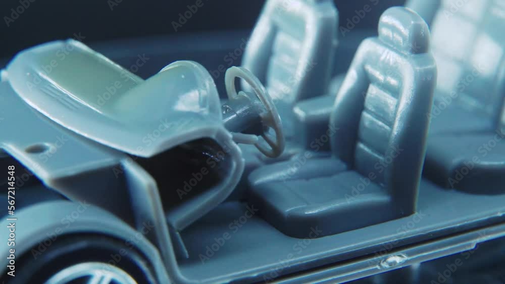 A tiny model metal sample skeleton of a car on a rotating stand with ...