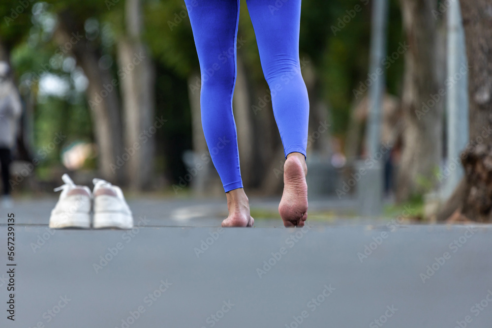 Woman runner is running barefoot without shoes to avoid bunion ...