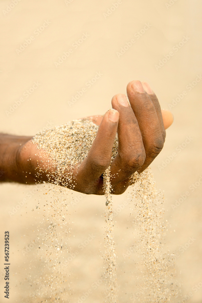 Climate change. Man holding sand in his hand. Symbolic representation ...