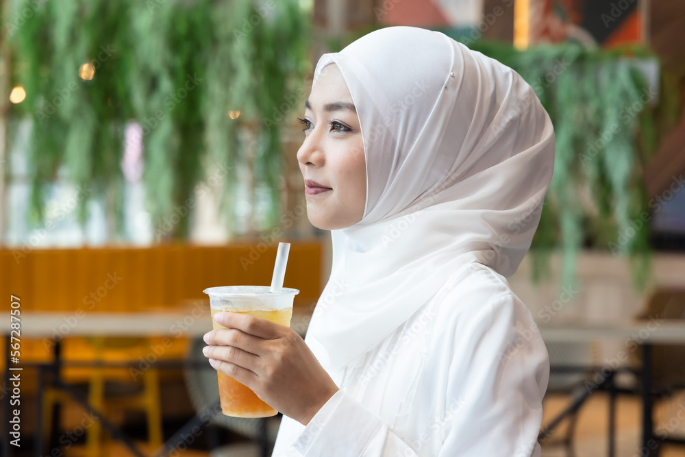 Happy Muslim woman drinking delicious halal boba tea aka bubble tea or ...