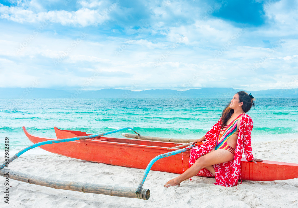 Transgender woman posing in colorful swimwear,on a boat,White Beach ...