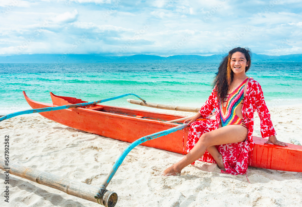 Transgender woman posing in colorful swimwear,on a boat,White Beach ...