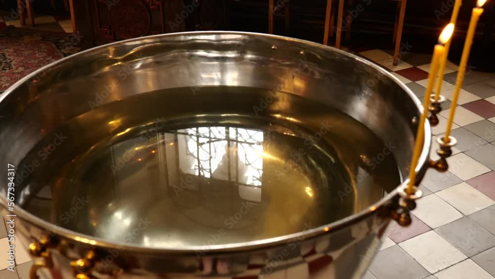 Orthodox baptism bowl of holy water with candles Stock Video | Adobe Stock