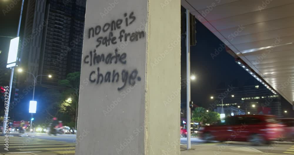 No one is safe from climate change - inscription in downtown with cars ...