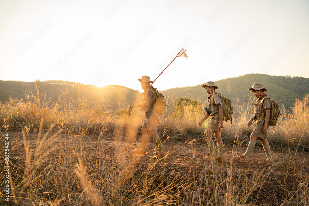 Asian Boy Scout students wearing scout uniforms and backpacks trekking ...