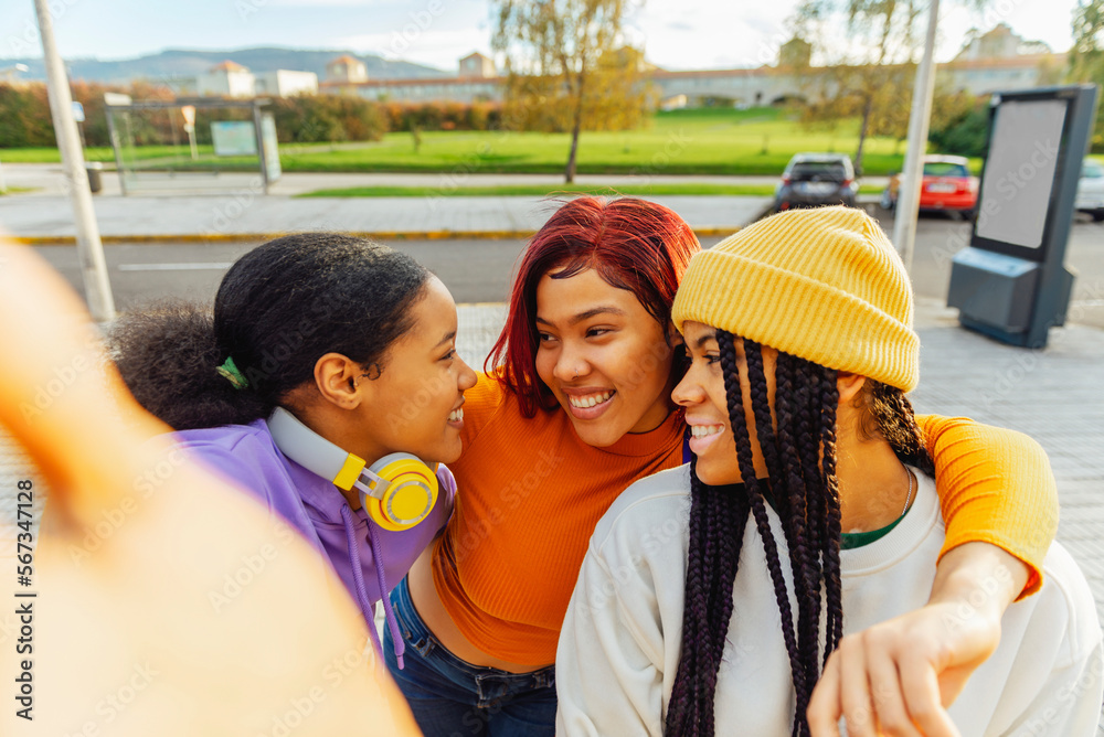 Foto de three young hispanic girls taking a picture as they leave class ...