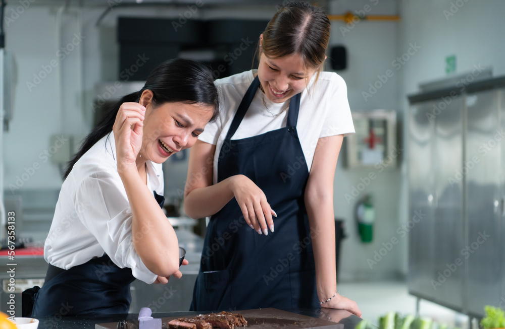 Students cooking apprentice after the steak is finished grilling, Try ...