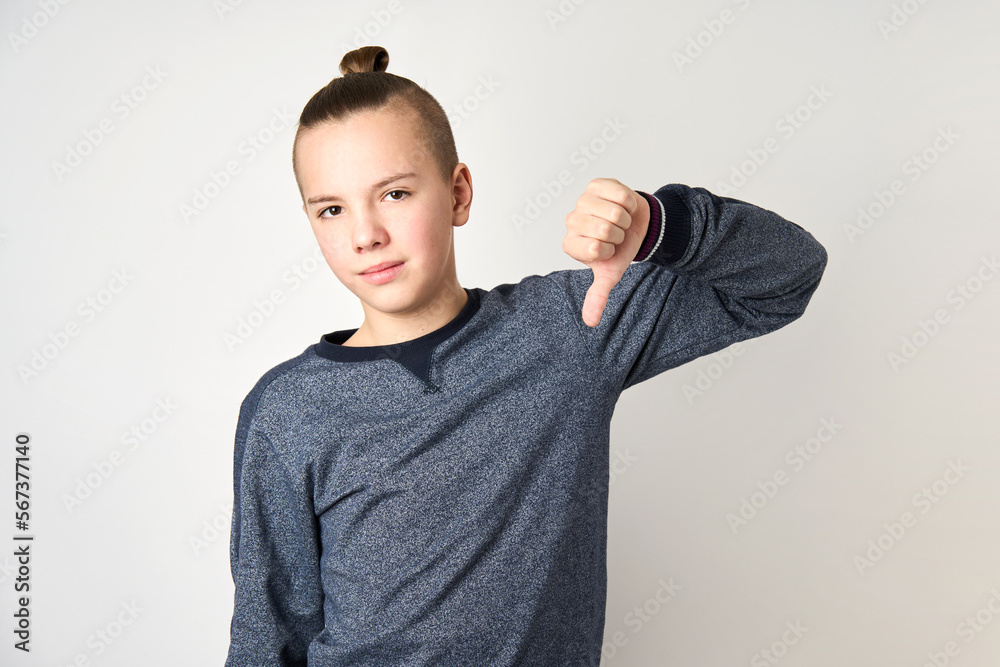 Young boy shows disapproval sign, white background Stock Photo | Adobe ...