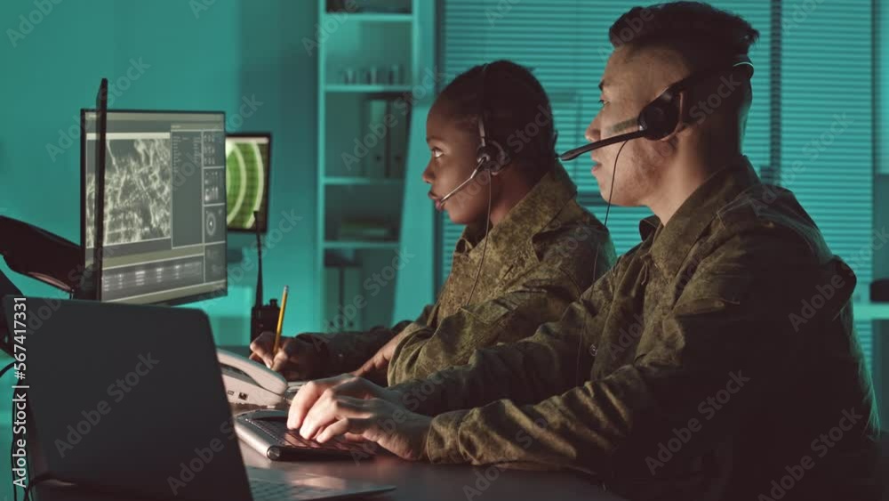 Two diverse male and female military surveillance officers in ...