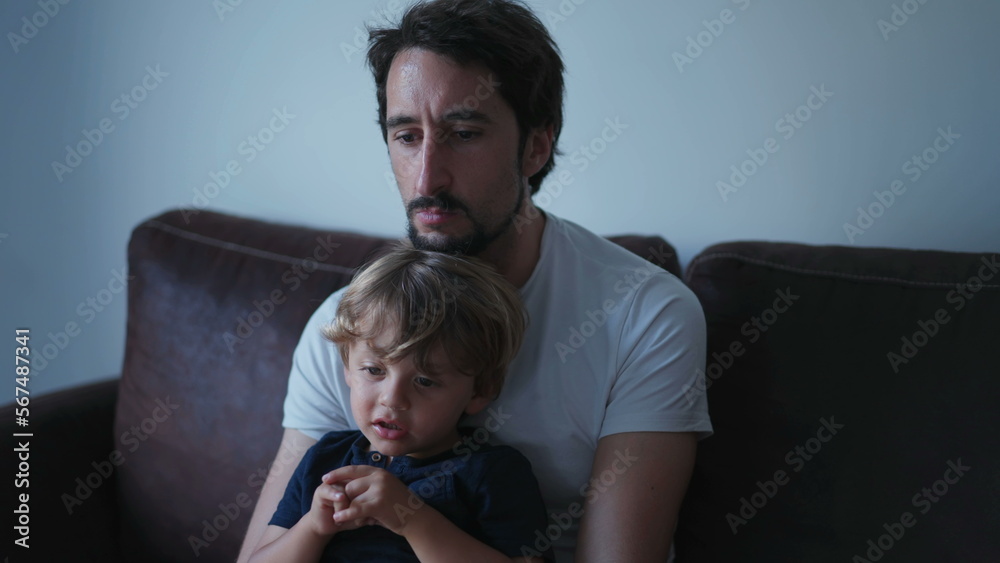 Father and son watching movie screen seated at home couch sofa. Child ...