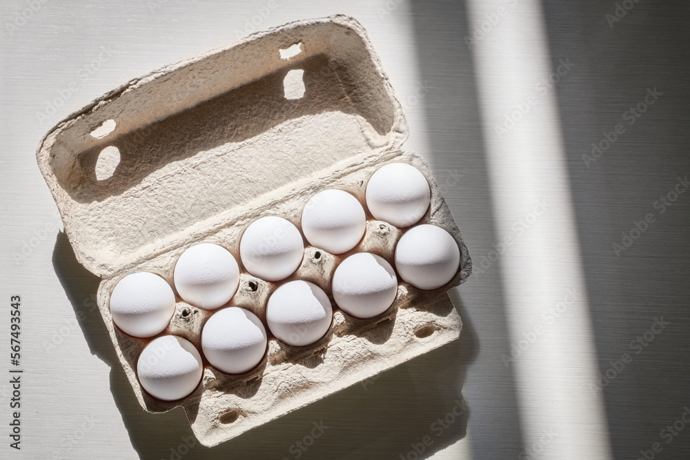 White eggs in paper egg box. Chicken eggs. Cardboard egg box on the ...