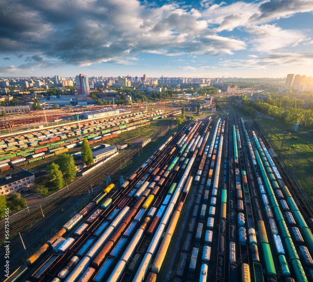 Drone view of freight trains at sunset. Colorful railway cargo wagons ...
