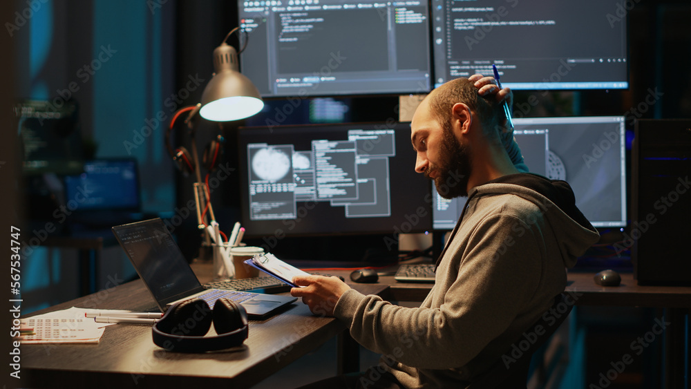 Male It Engineer Analyzing Web Data On Clipboard Papers And Screens Comparing Information On