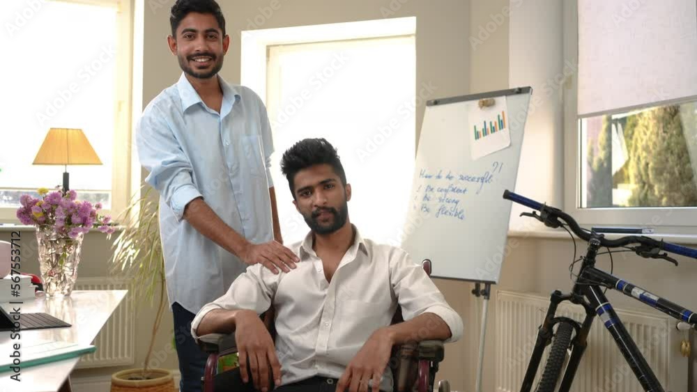 Stockvideo Young positive man tapping shoulder of friend in wheelchair ...