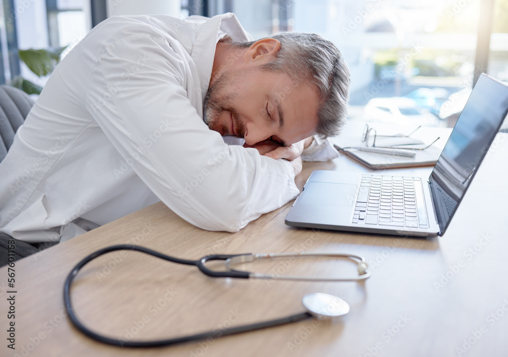 Man, doctor and laptop sleeping on desk from burnout, overworked or ...