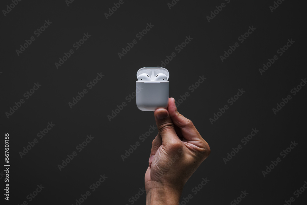 PENANG, MALAYSIA - MAR 24, 2020: One hand holding the Apple Airpod with ...