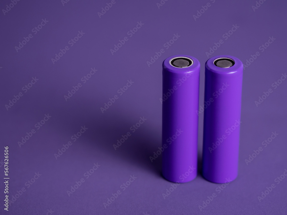 Battery. Cylindrical battery, type 18650 on a purple background ...
