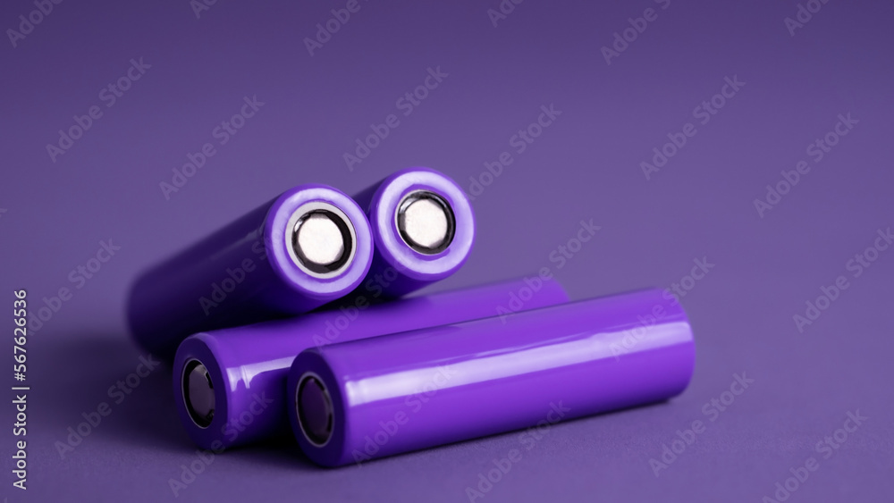 Battery. Cylindrical battery, type 18650 on a purple background ...